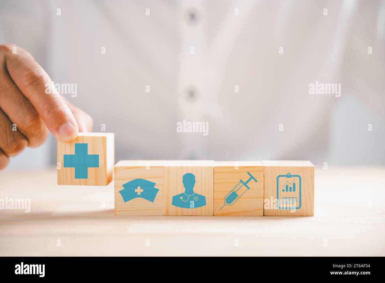 Hand hold wooden block with icon healthcare medical Stock Photo - Alamy