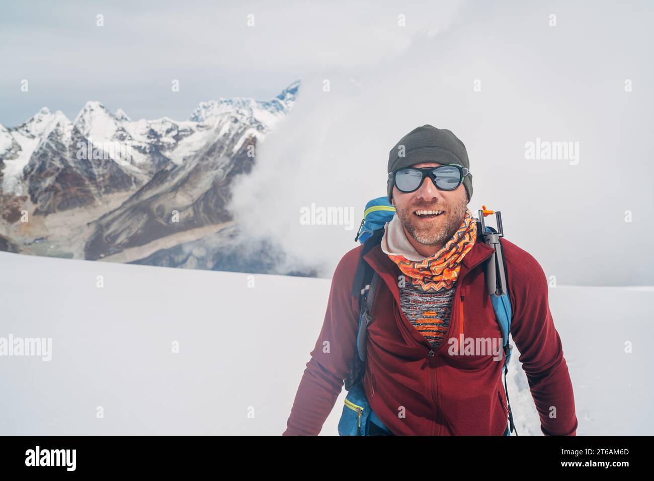 Cheerful laughing climber in sunglasses portrait with backpack ...