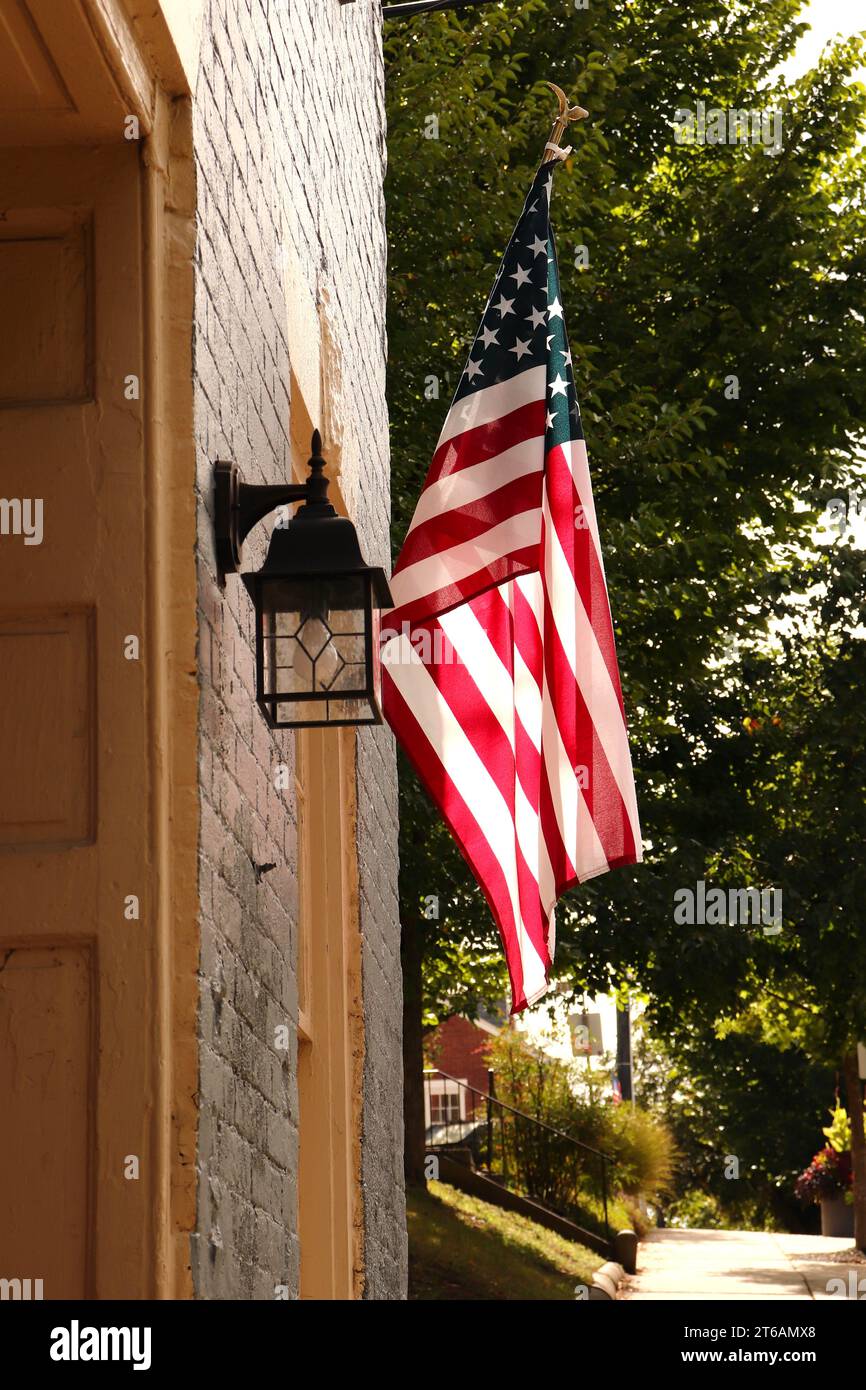 American Flag Hangs from Building Wall Stock Photo - Alamy