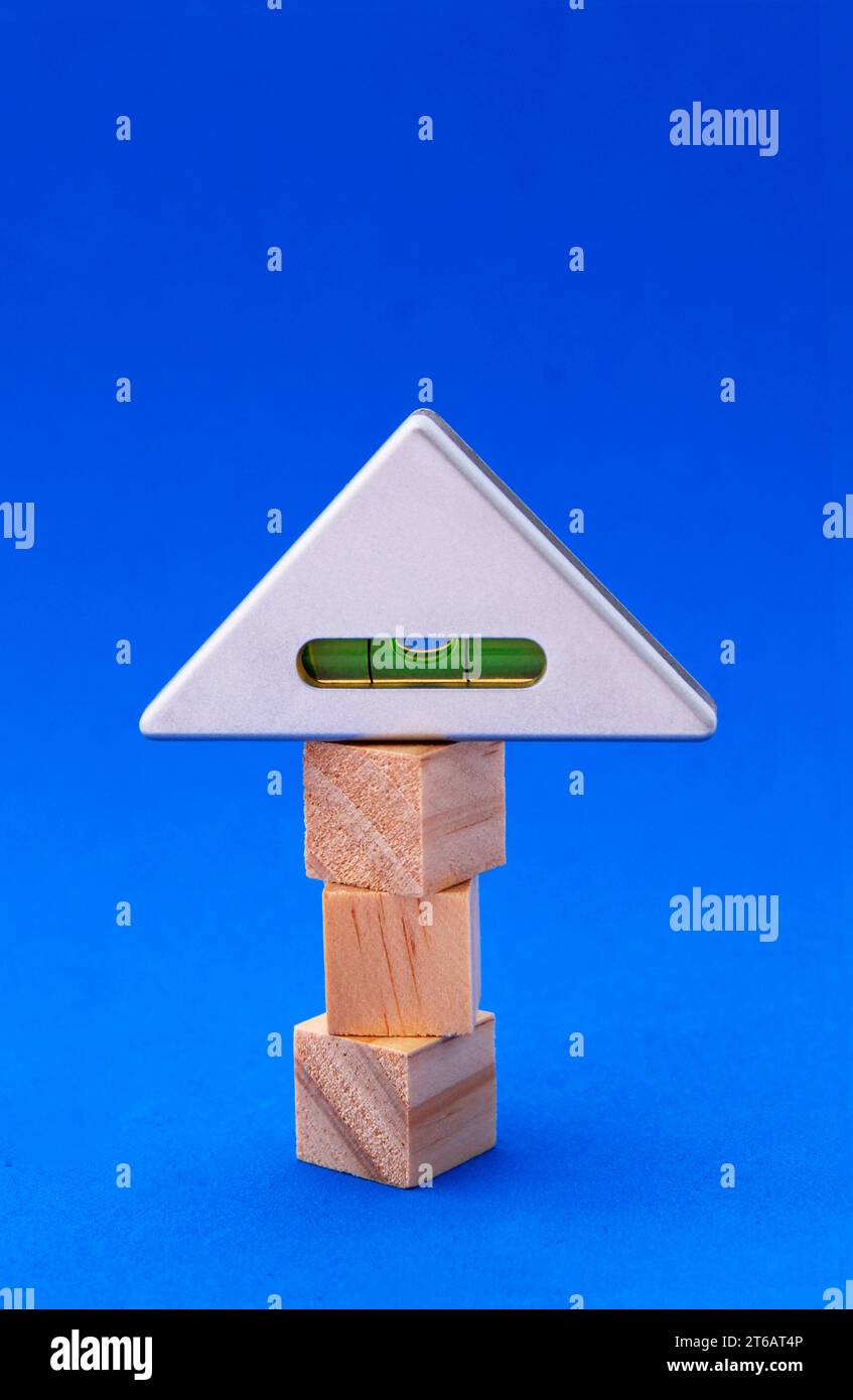 Triangular bubble level on three wooden blocks Stock Photo - Alamy