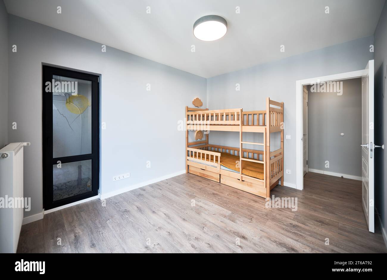 Kid bedroom with parquet floor, child house bed, white walls and open ...