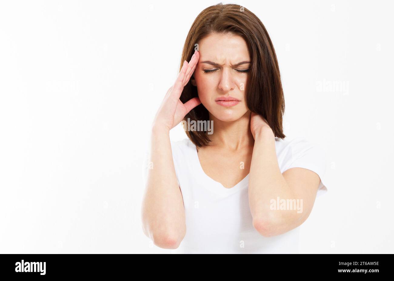 brunette Woman suffering from stress or headache grimacing in pain as ...