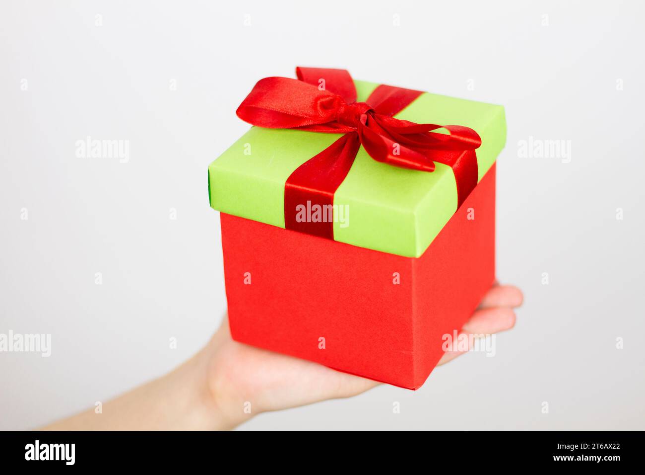 Hands holding beautiful gift box, female giving gift isolated, mock up ...