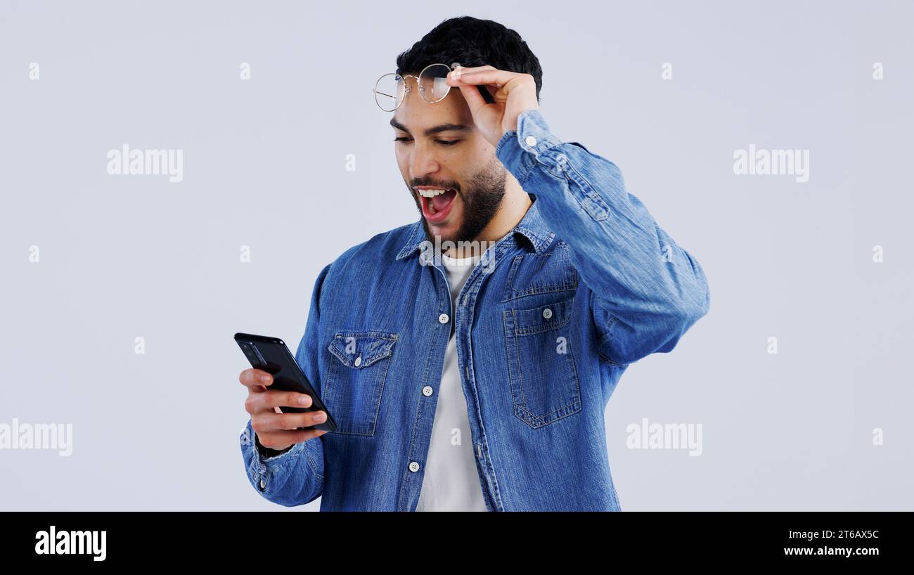 Man, smartphone and excited with winner notification with surprise on ...