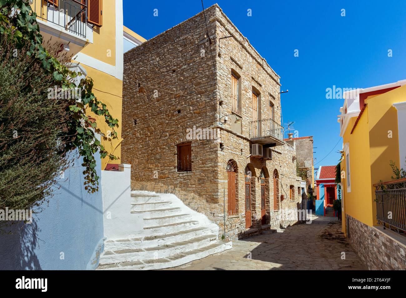 Colorful facades of traditional Greek multi-colored houses on a narrow ...