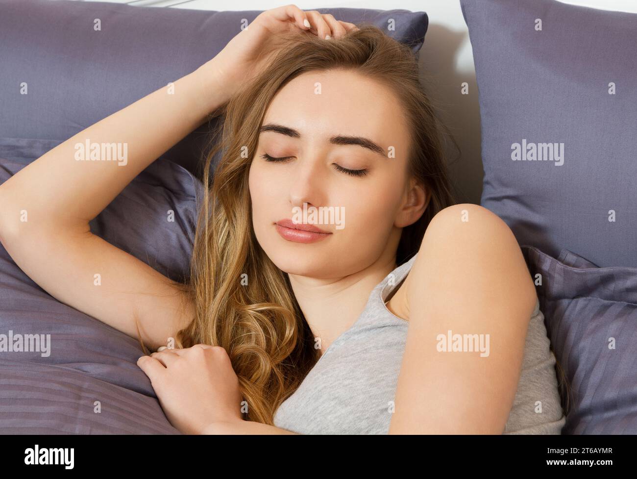 portrait of a beautiful smile girl with closed eyes on the bed after sleep Stock Photo - Alamy