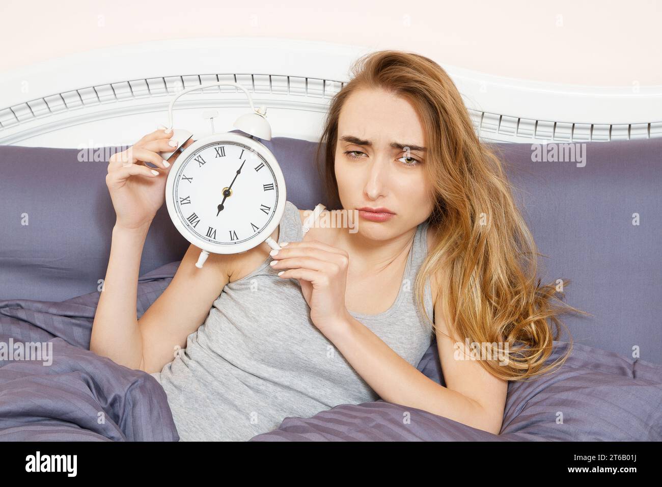 Shocked young woman waking up with alarm, overslept work, bad sleep ...