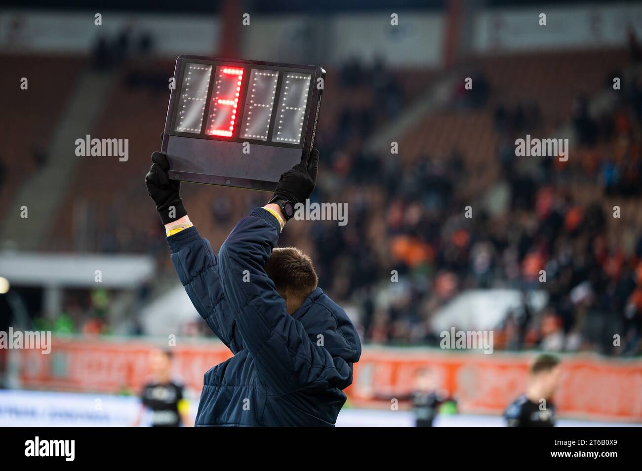 Sideline referee shows 4 minutes added time during the football match ...