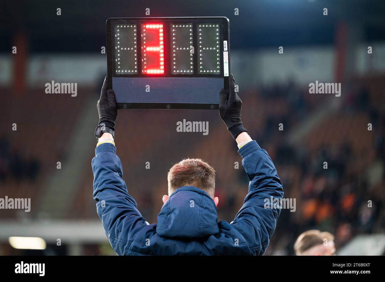 Sideline referee shows 4 minutes added time during the football match ...