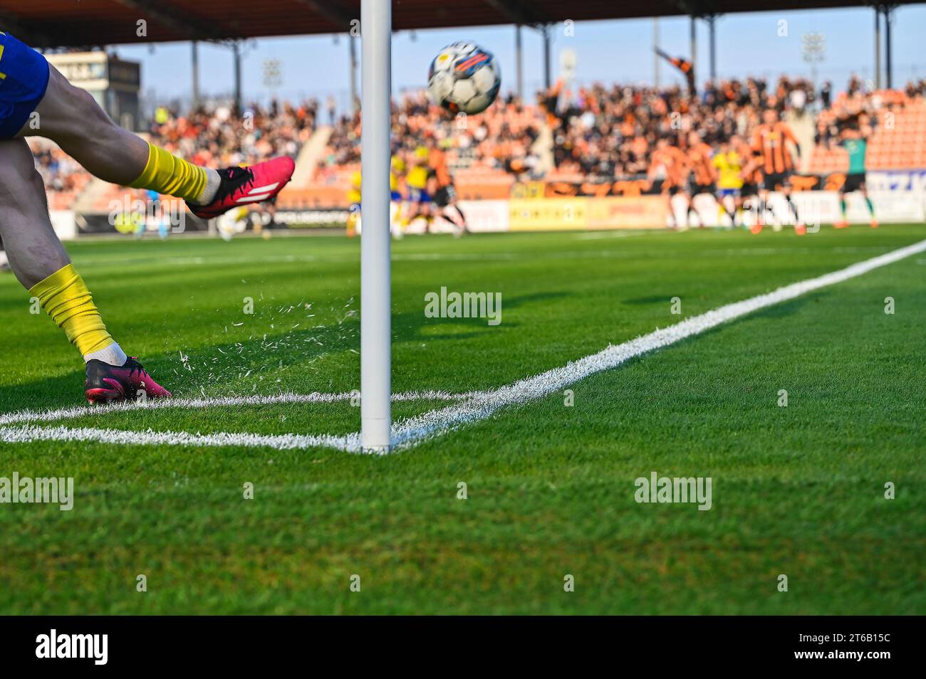 Footballer takes the corner. Detail of player's legs and the ball ...