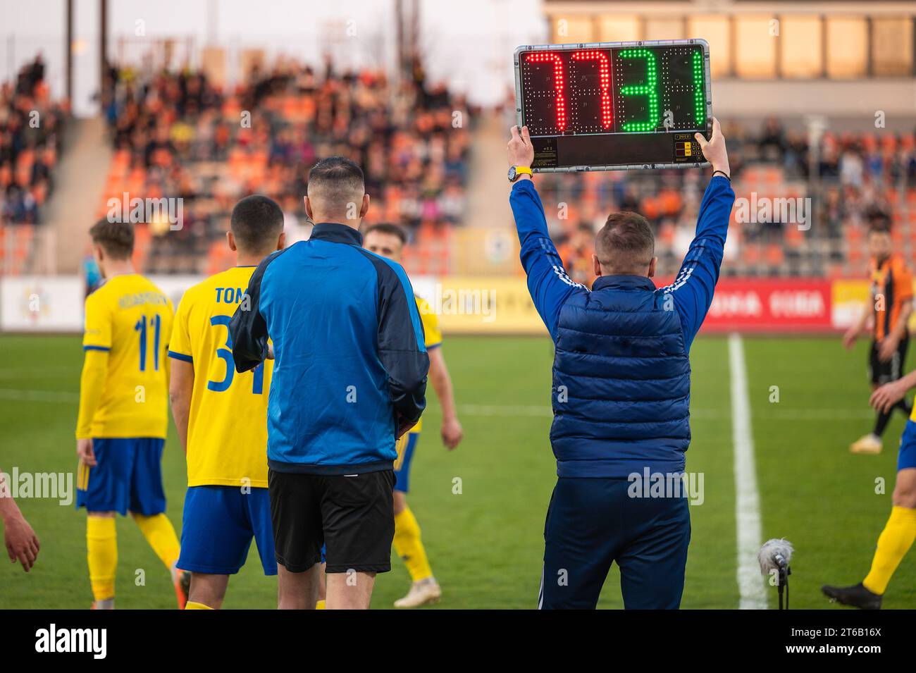 Man shows players substitution during football match Stock Photo - Alamy