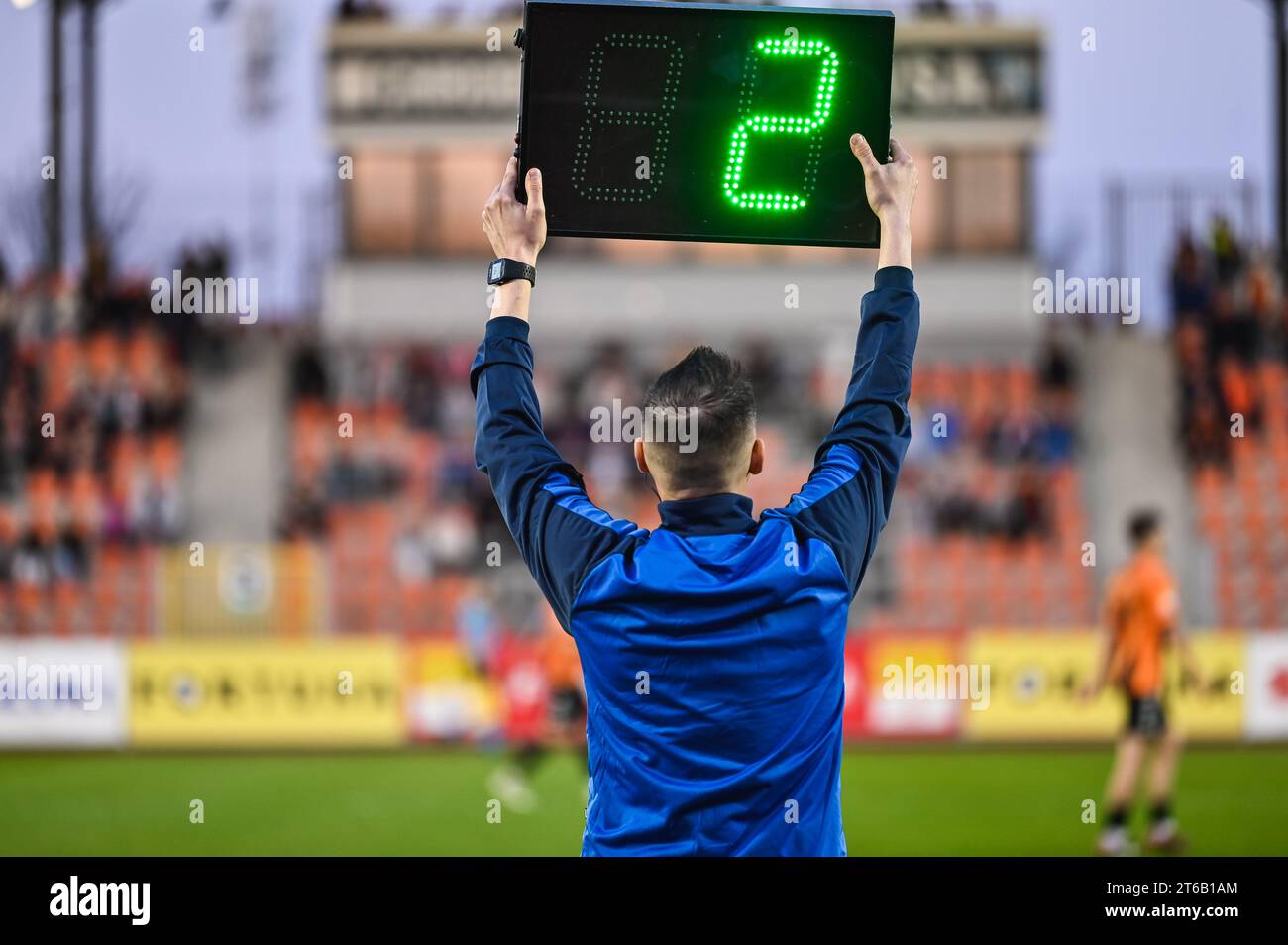 Sideline referee shows 2 minutes added time during the football match ...