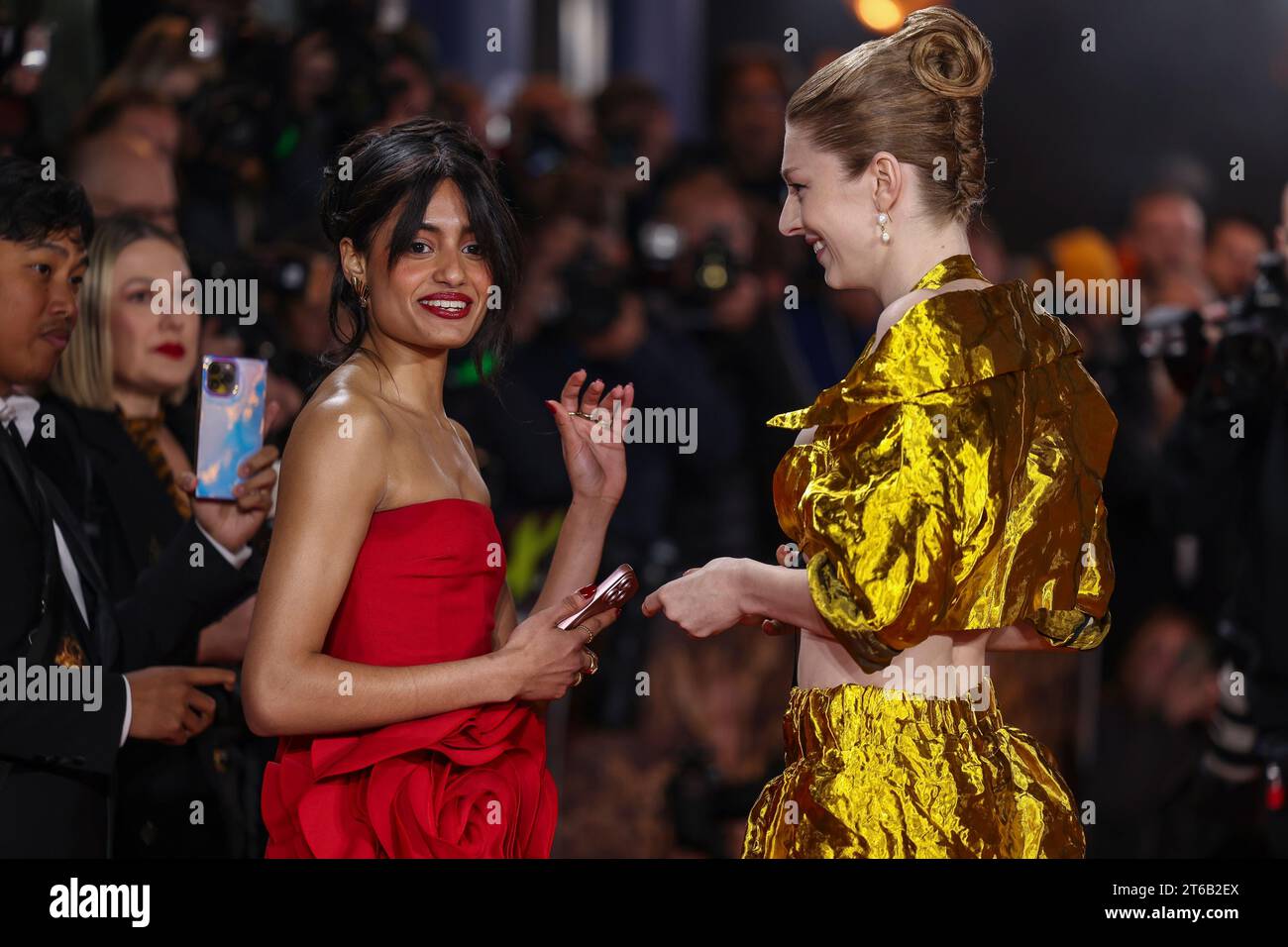 Sabrina Bahsoon, left, and Hunter Schafer pose for photographers upon ...