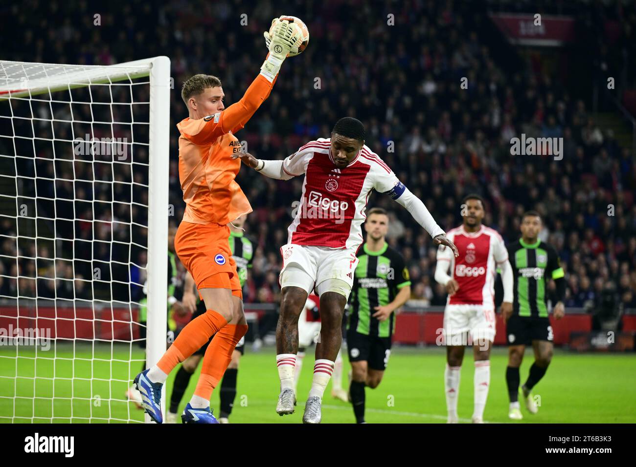 AMSTERDAM - (l-r) Brighton Hove Albion goalkeeper Bart Verbruggen, Steven Bergwijn of Ajax ...