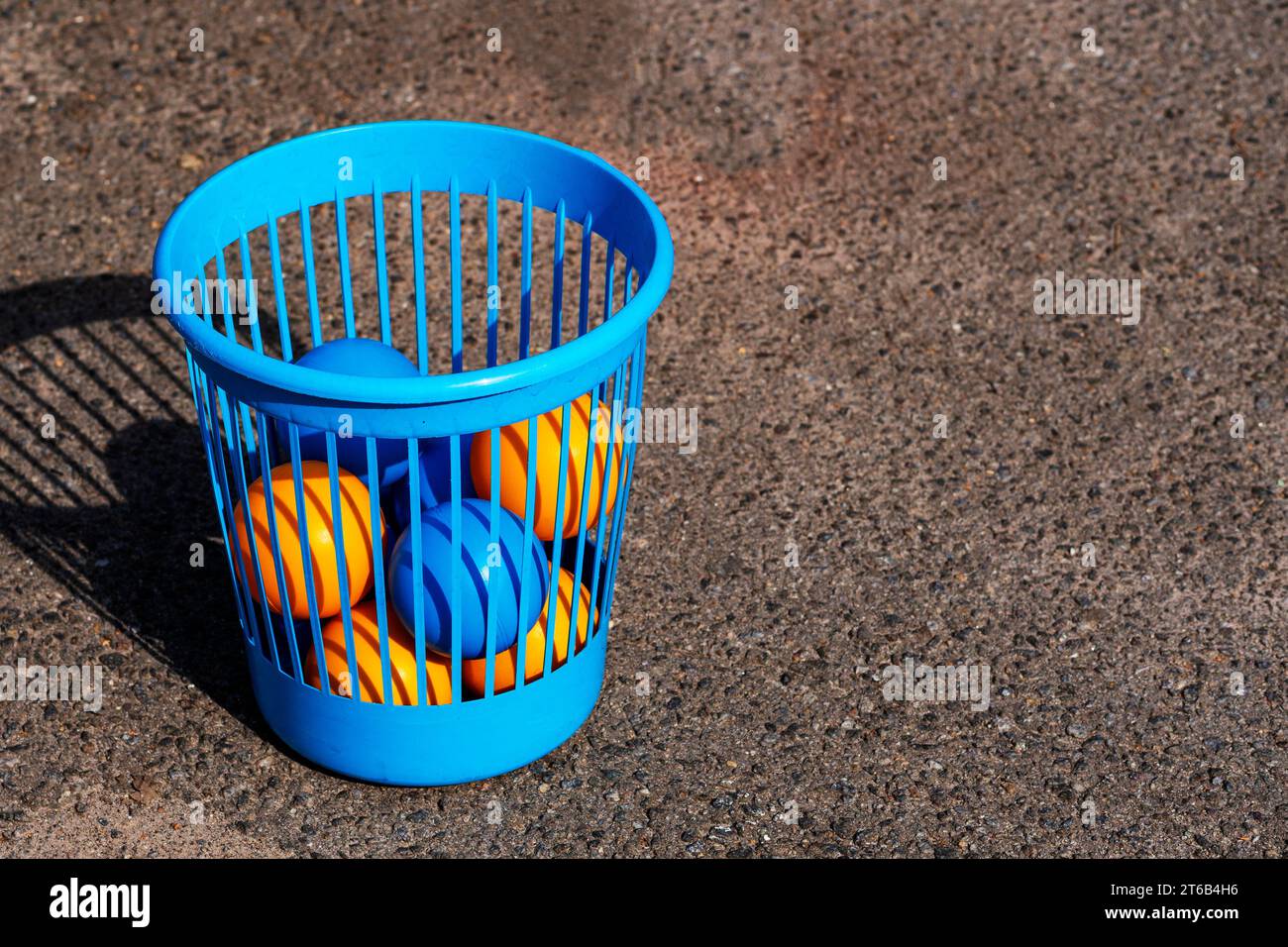 Blue box with colored balloons. Basket with balls of two colors ...
