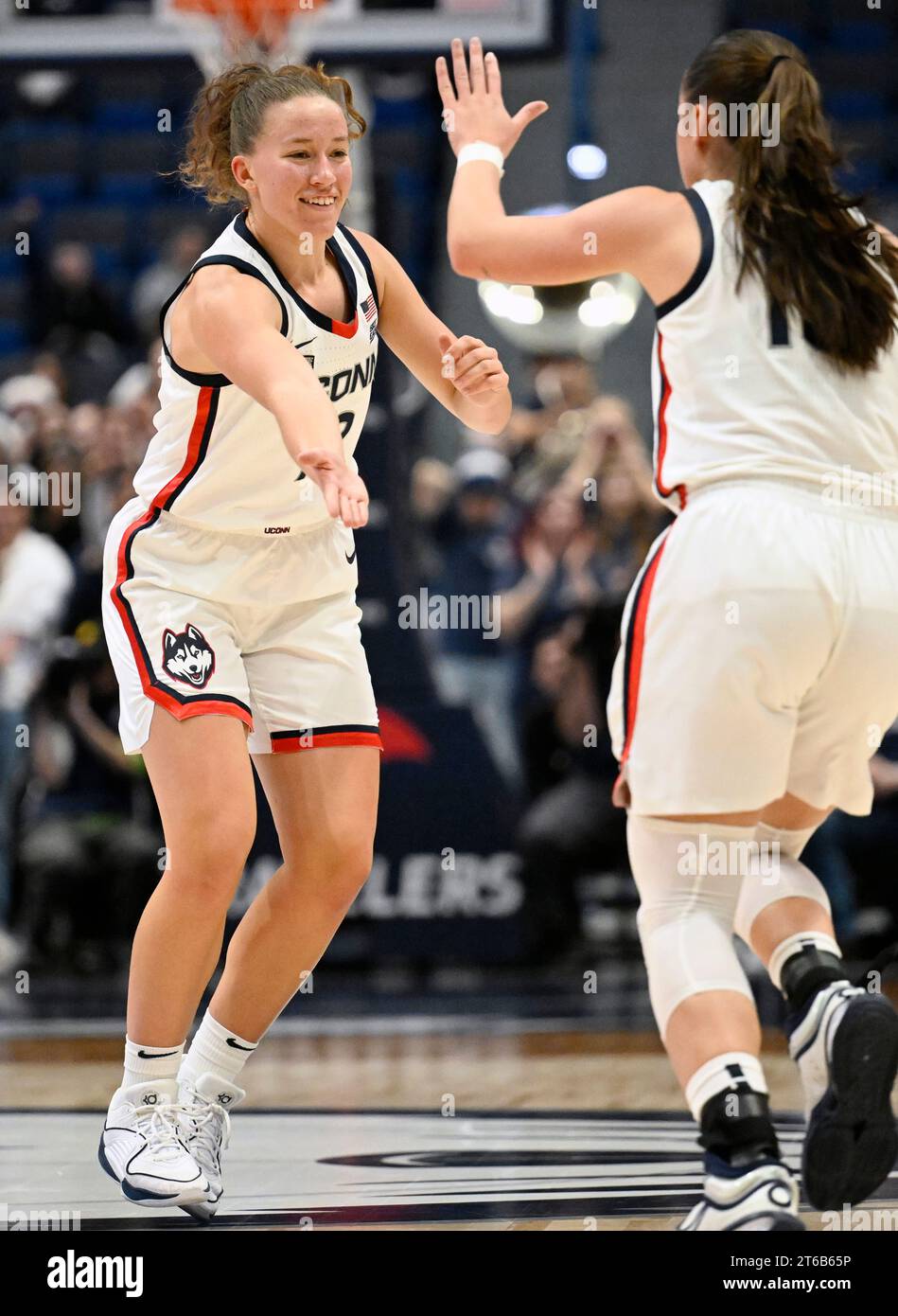 UConn guard Ashlynn Shade (12) slaps hands with UConn guard Nika Muhl ...