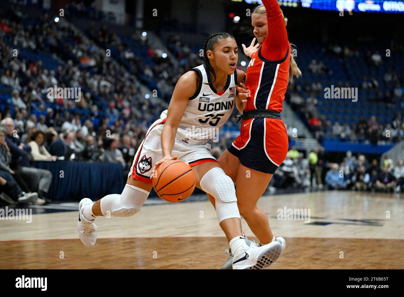 UConn guard Azzi Fudd (35) dribbles around Dayton guard Ivy Wolf (10 ...