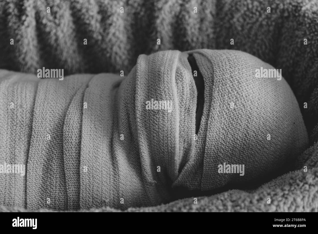 The man is wrapped in a cloth. The body is shrouded in a veil. The ...