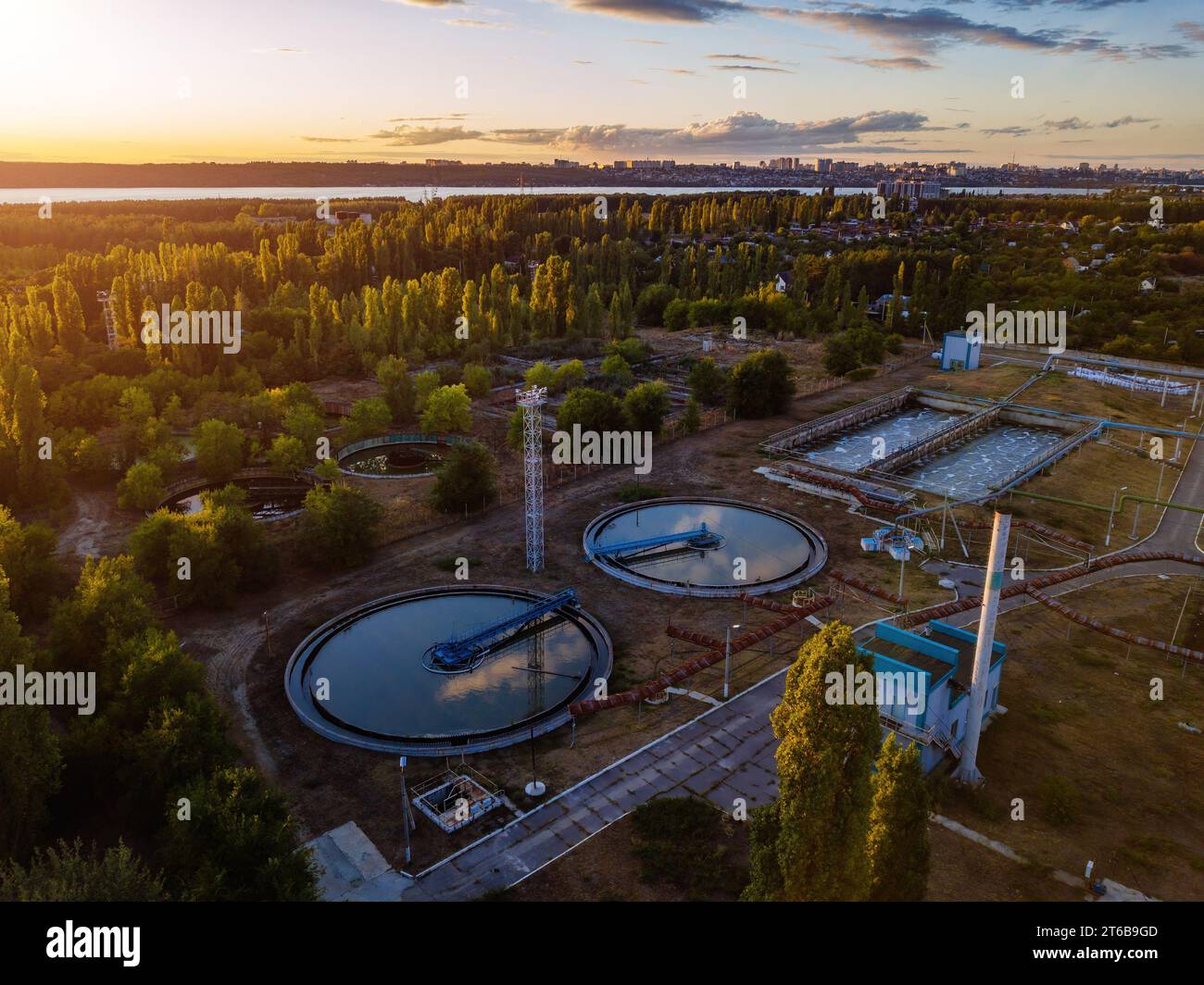 Modern sewage treatment plant. Wastewater purification tanks at sunset ...