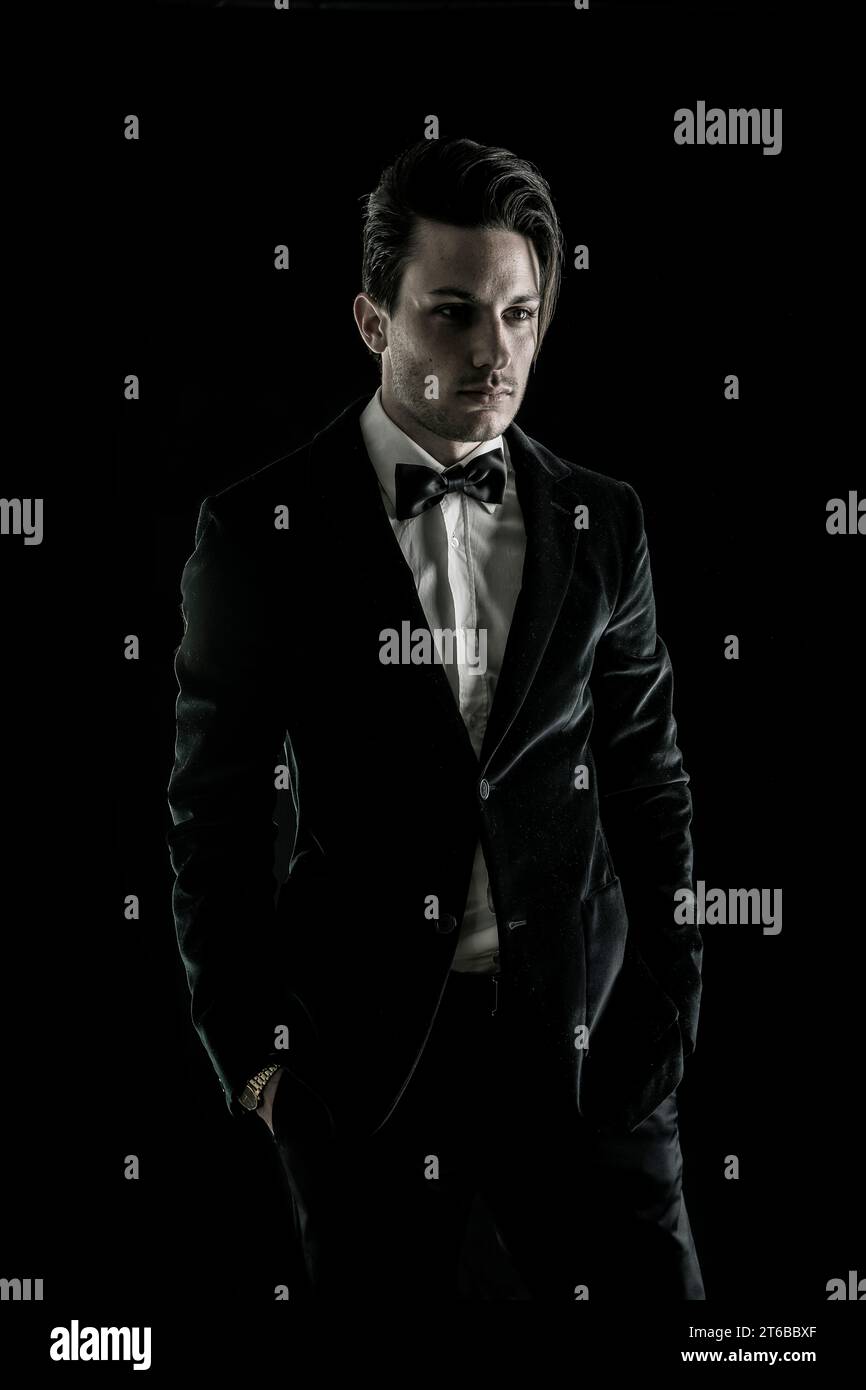 A man in a tuxedo poses for a picture Stock Photo - Alamy