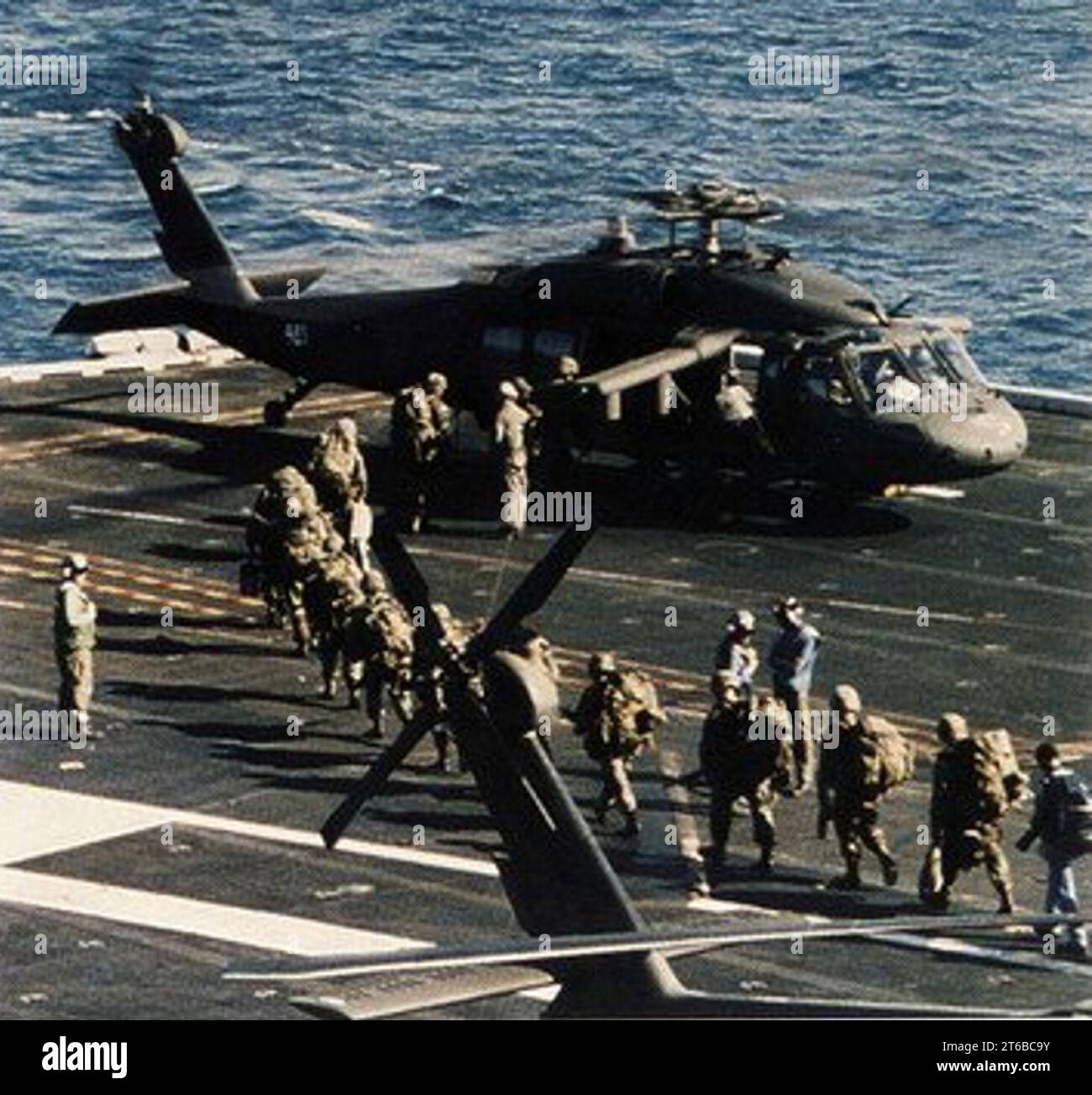 US soldiers board UH-60 on USS Eisenhower (CVN-69) off Haiti in 1994 ...