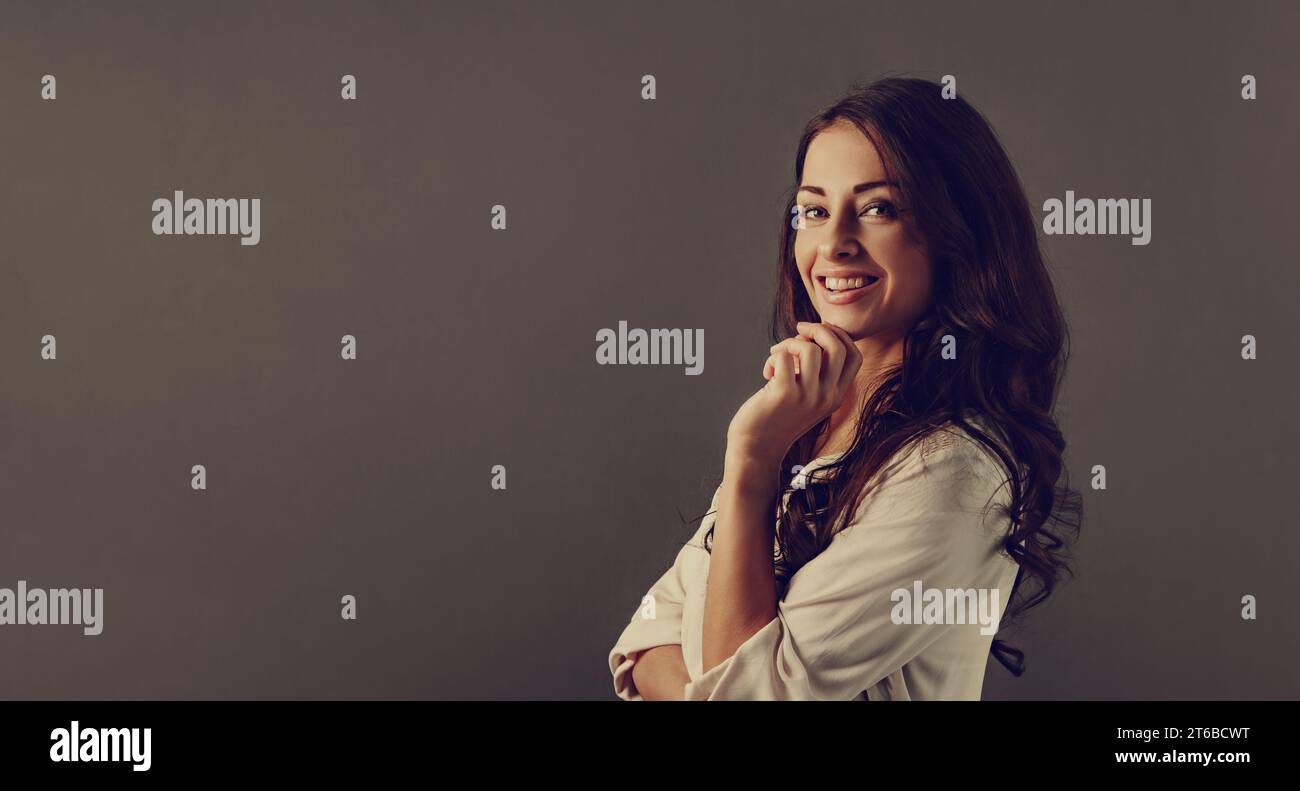 Beautiful happy smiling woman with long brown curly healthy hair style ...