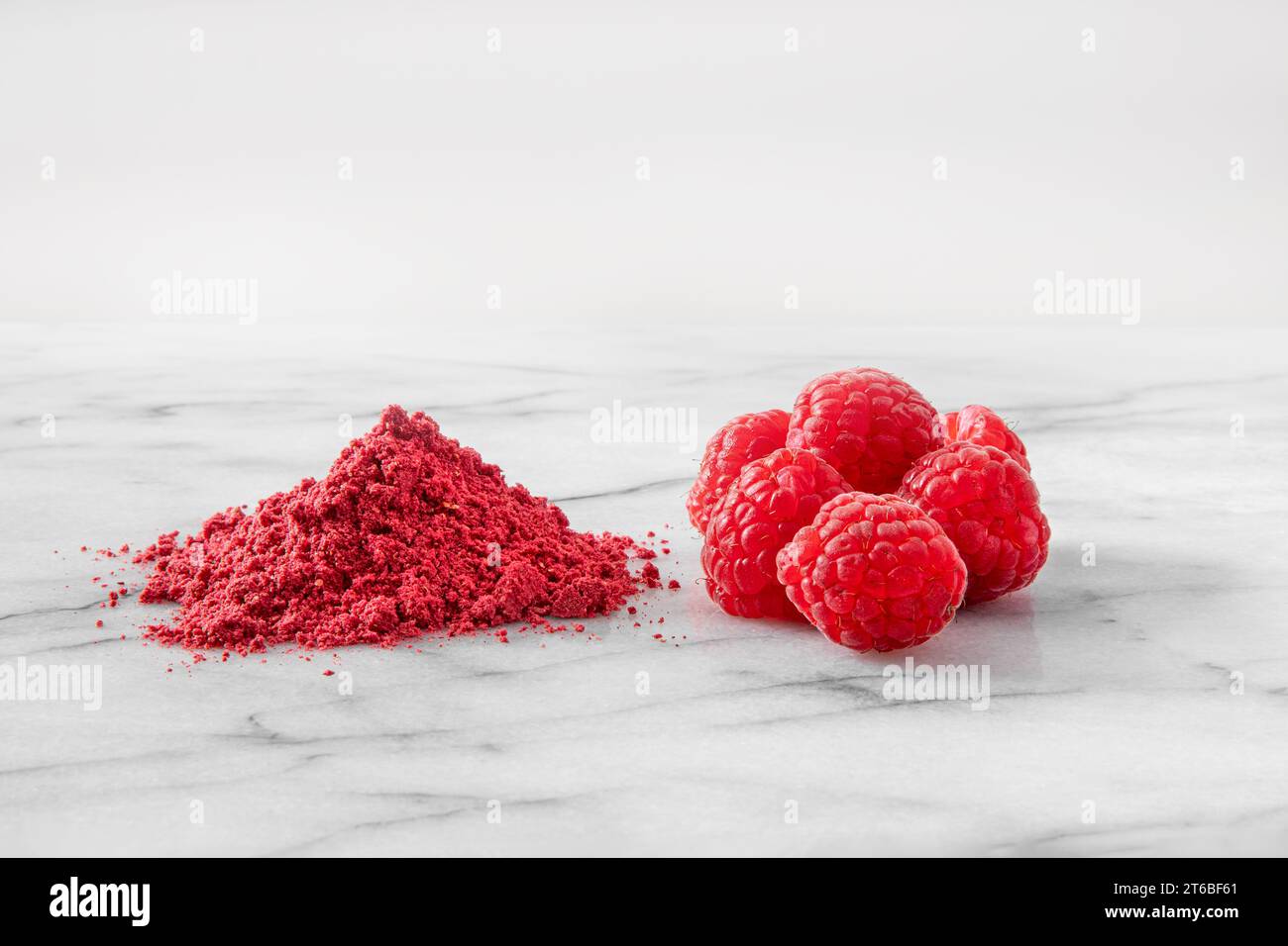Dehydrated raspberry powder with raspberries on the side Stock Photo ...