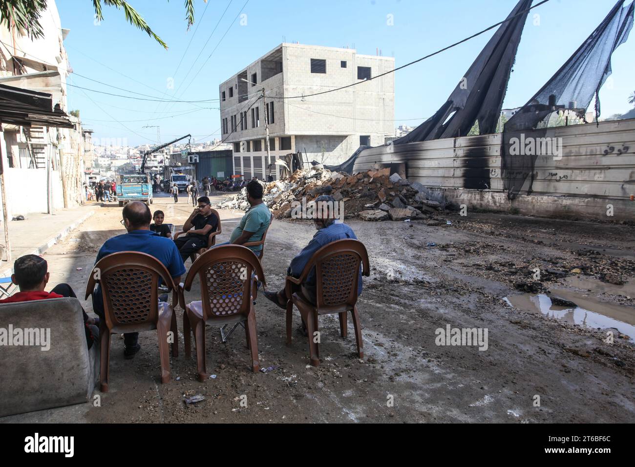 Tulkarm, Palestine. 08th Nov, 2023. Palestinians sit amidst the damages ...