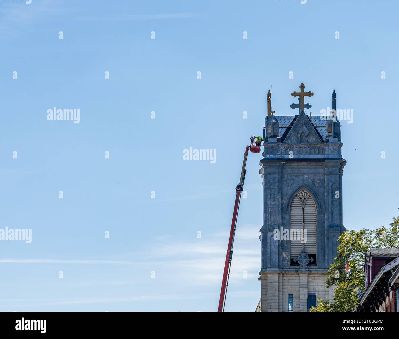 Articulating boom lift used to reach top of church tower and allow ...