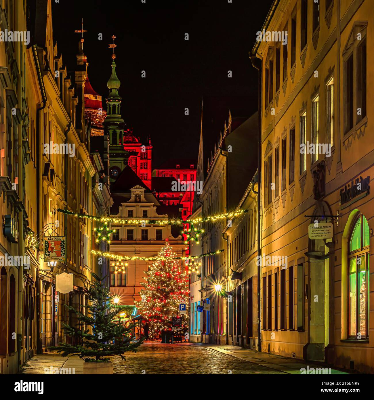 An aerial view of a cobblestone-paved street in a bustling cityscape ...