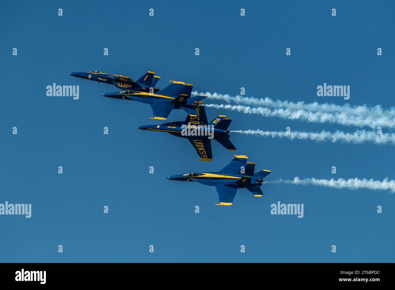 Five sleek jet airplanes flying in formation, leaving long contrails in ...