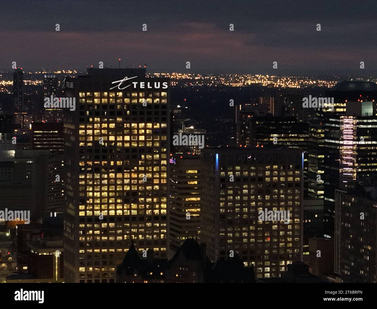 Aerial view of a cityscape at night with illuminated tall buildings and ...