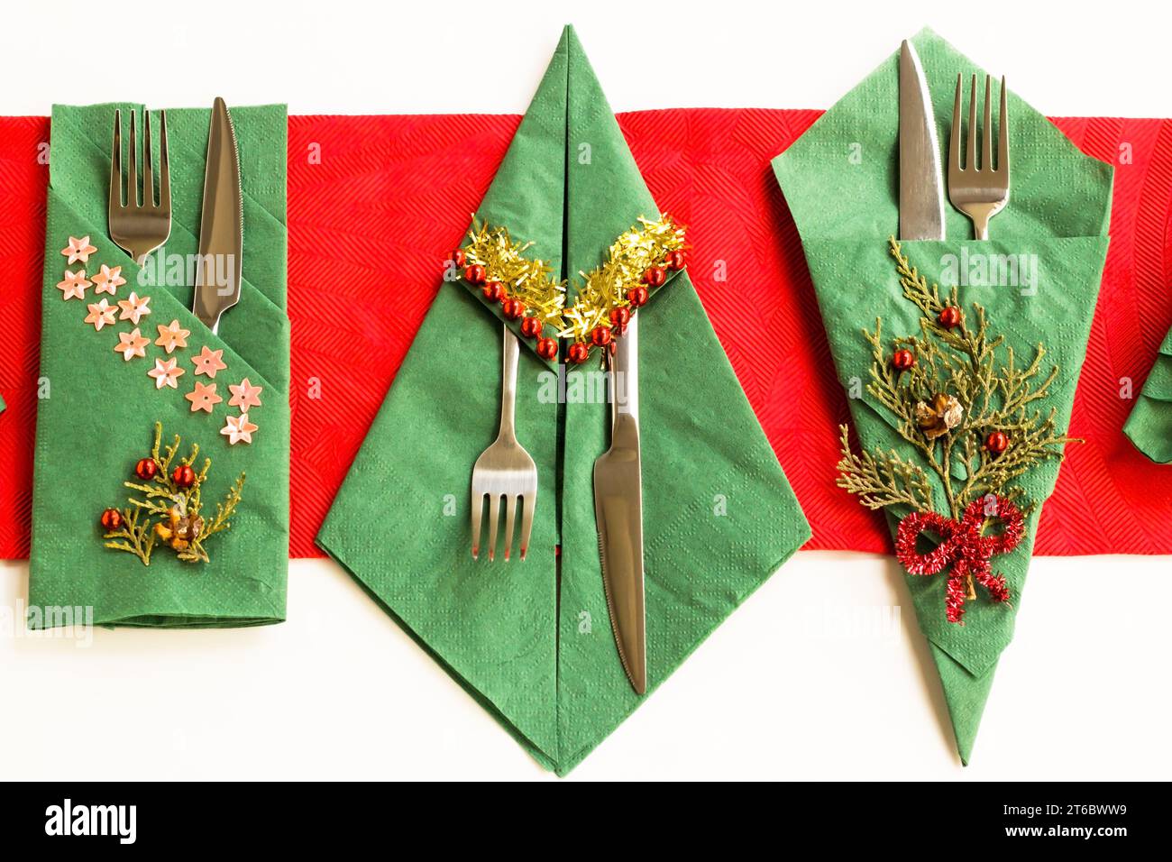 Red and green colored Christmas Napkins folded in different shapes on ...