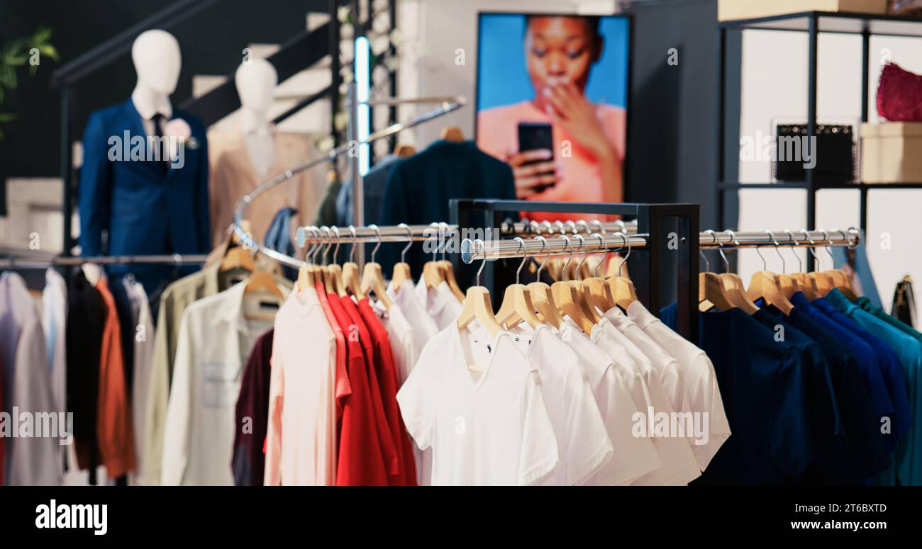 Empty clothing store in shopping mall, new fashion collection on shelf ...