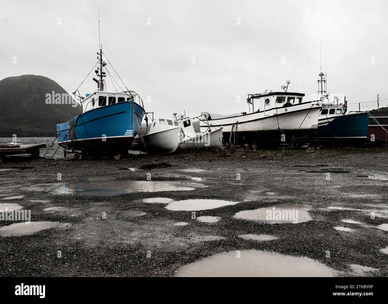 Rainy day at Lark harbour with large puddles near dry docked fishing ...