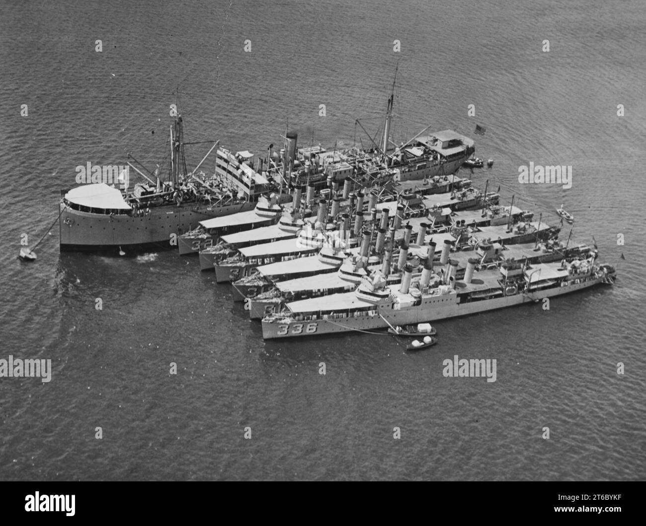 USS Altair (AD-11) moored in Pearl Harbor with destroyers on 8 February ...