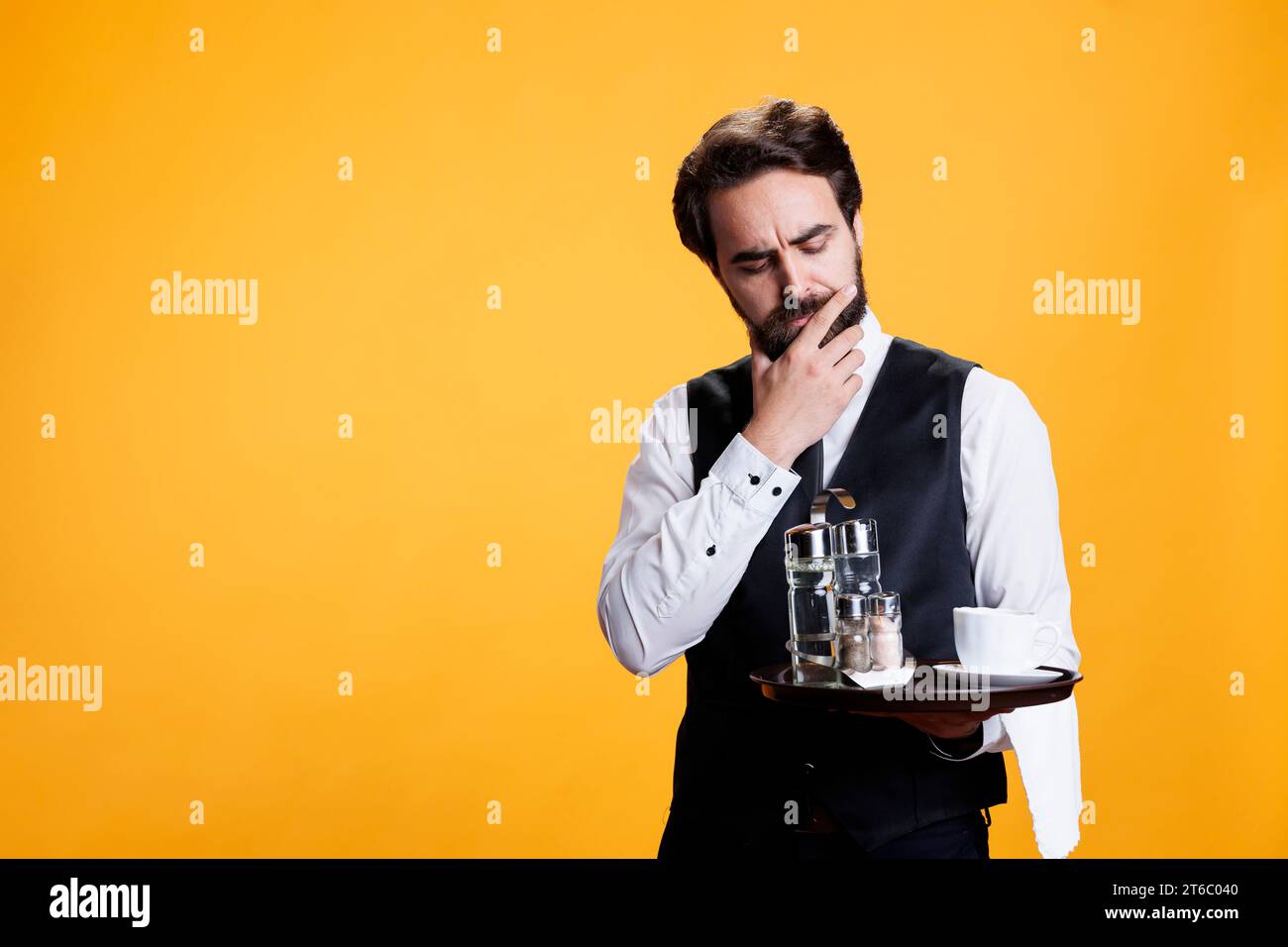 Luxury butler thinking about ideas, preparing to serve customers with ...