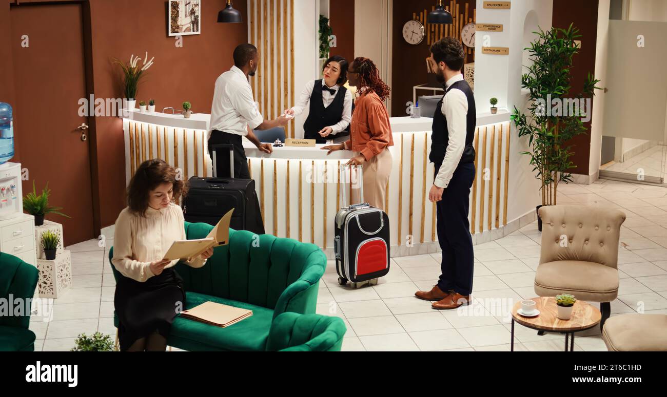 Friendly professional bellhop employee helping hi-res stock photography ...