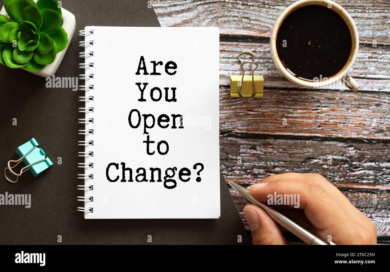 are you open to change. two notepads with text. near bright stationery ...