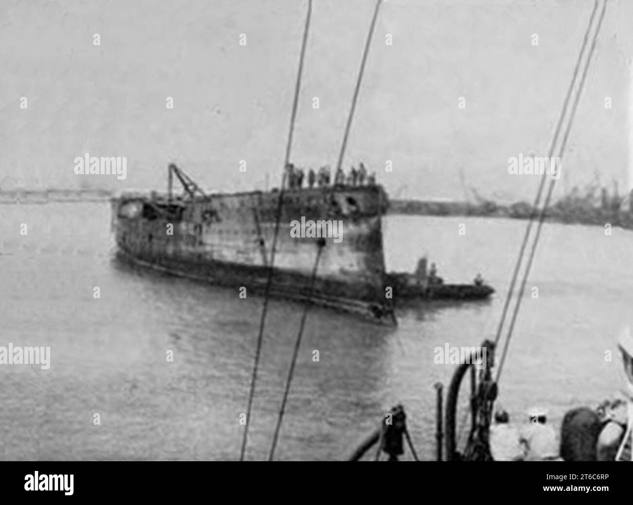USS Baltimore being examined by Seabees of the 133rd Naval Construction ...