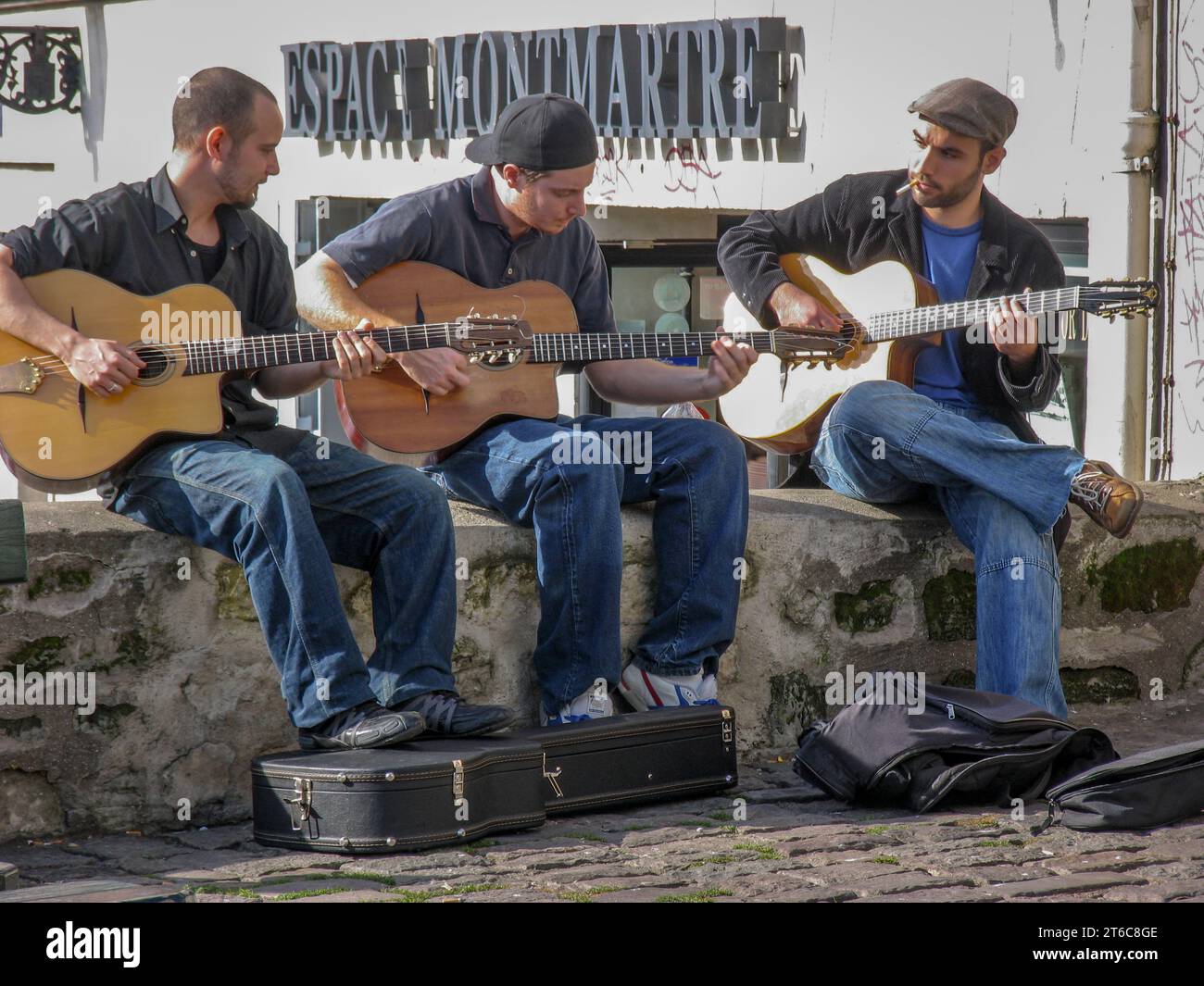 Three musicians play outside on the street in Montmartre in Paris ...