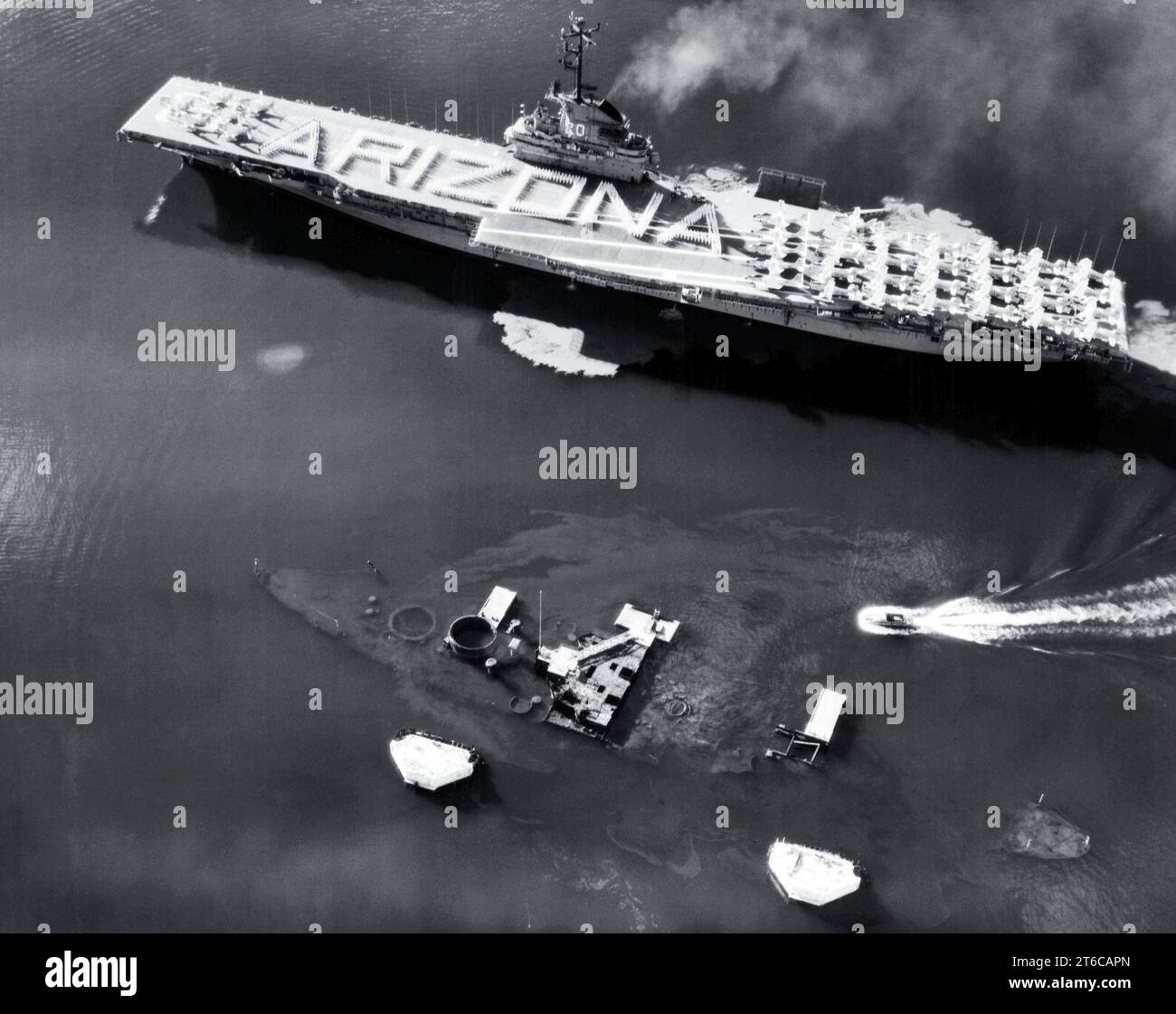 USS Bennington (CVA-20) passes the wreck of USS Arizona (BB-39) in ...