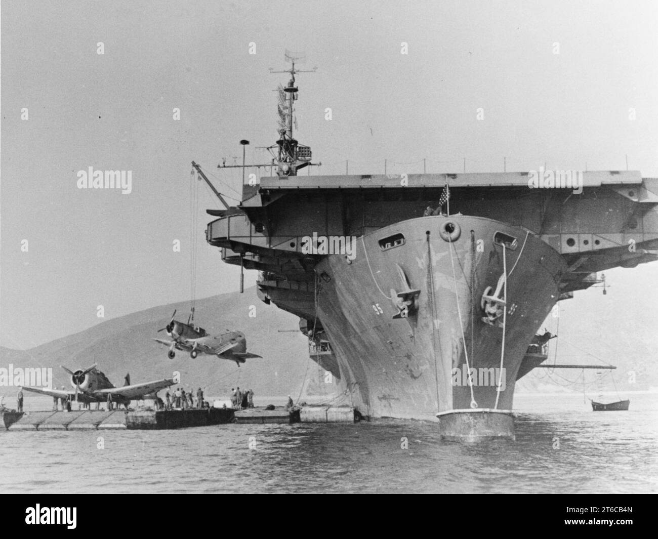 USS Bismarck Sea (CVE-95) loading Douglas SBD Dauntless bombers from a ...