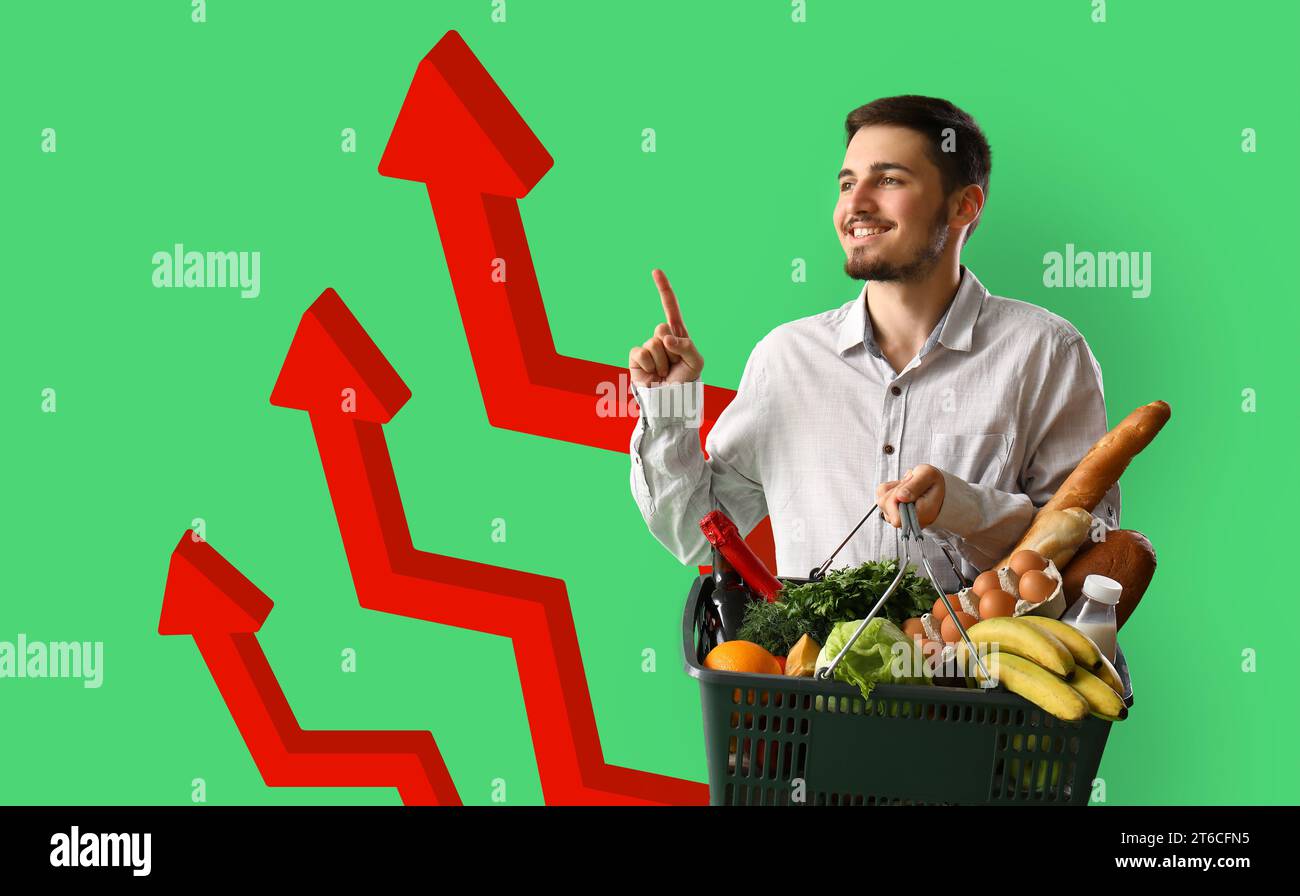 Man holding shopping basket with products on green background. Food ...