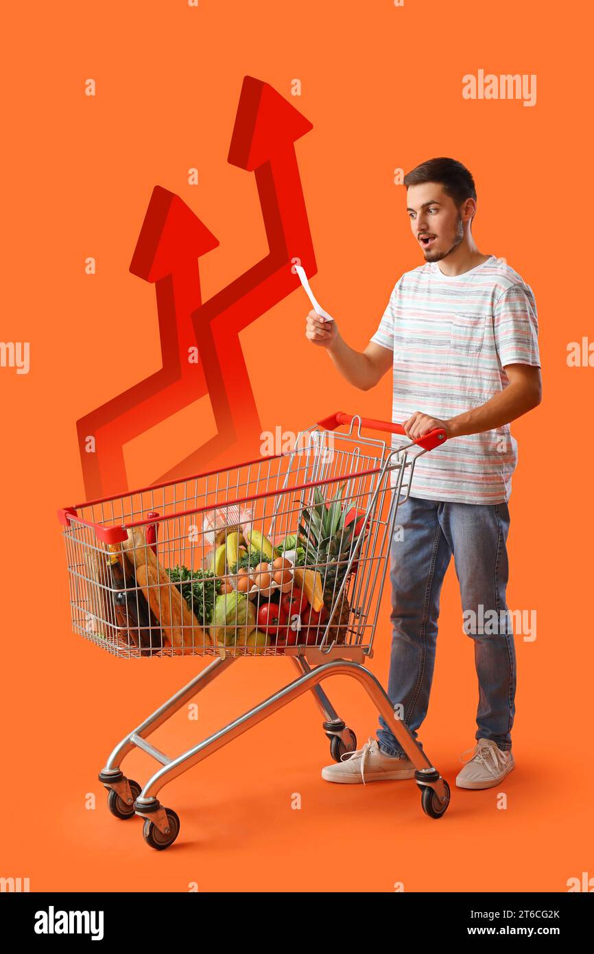 Shocked man with shopping cart and list of products on orange ...