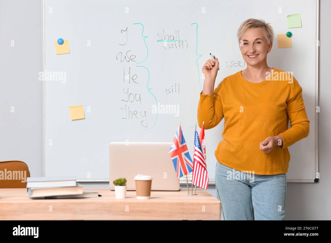 Female English teacher giving online lesson in classroom Stock Photo ...