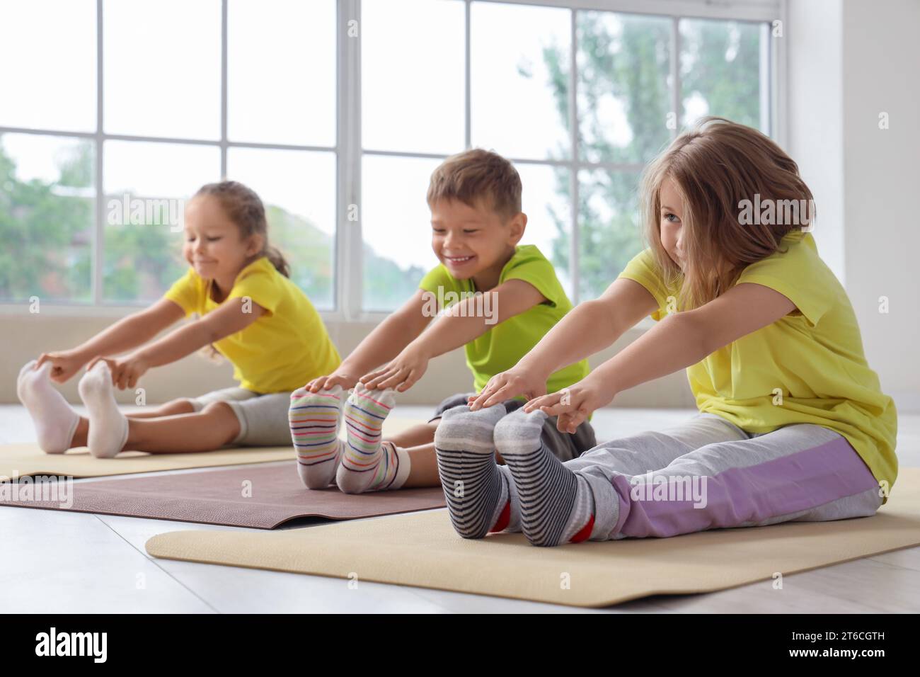 Group of little children practicing yoga in gym Stock Photo - Alamy