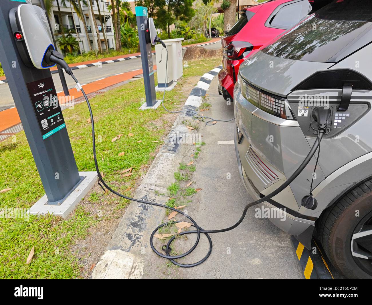 Scene of cars using EV charging point or station at the resort parking ...