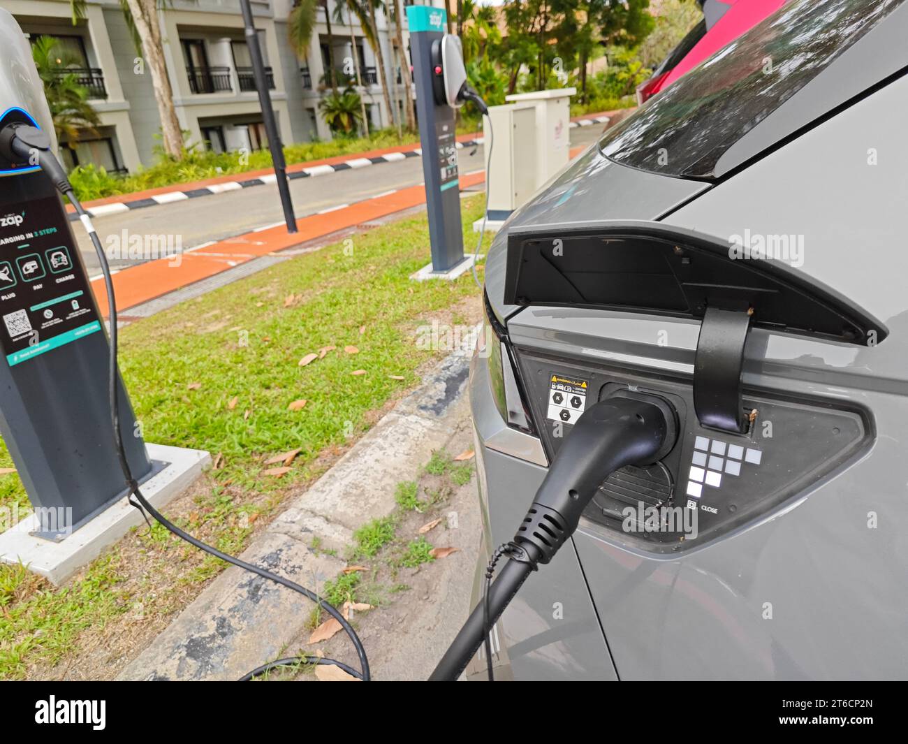 Scene of cars using EV charging point or station at the resort parking ...