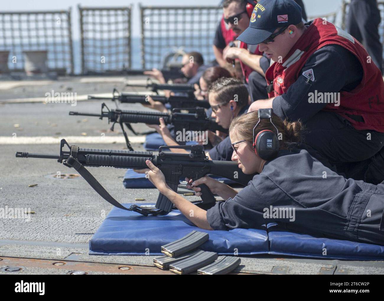 USS Bulkeley (DDG-84) sailors participating in small arms qualification ...